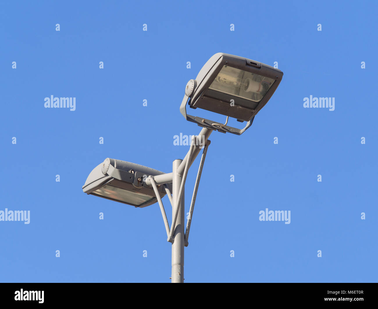 detail of a modern metal street light in a sunny day, alogen lamp is ...