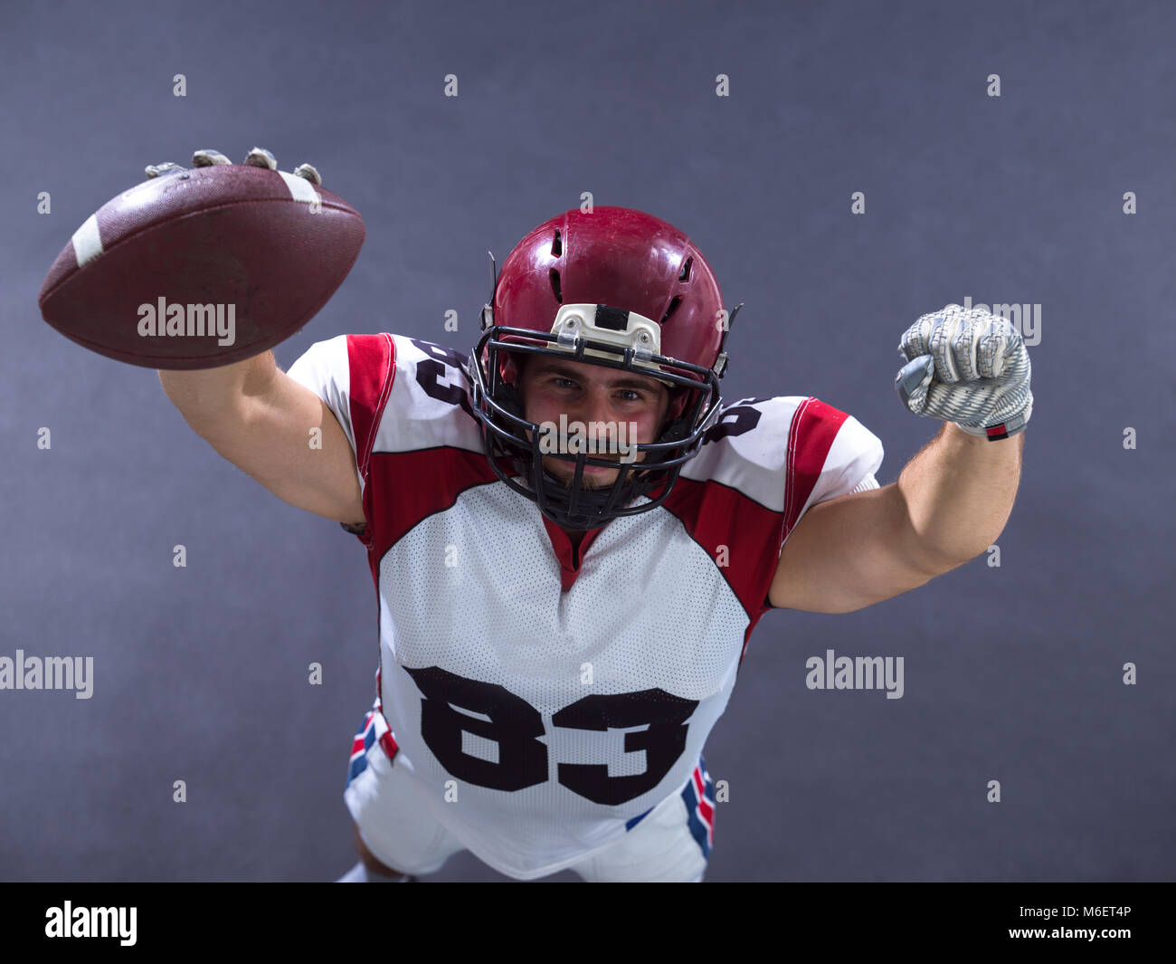 american football player celebrating touchdown isolated on gray ...