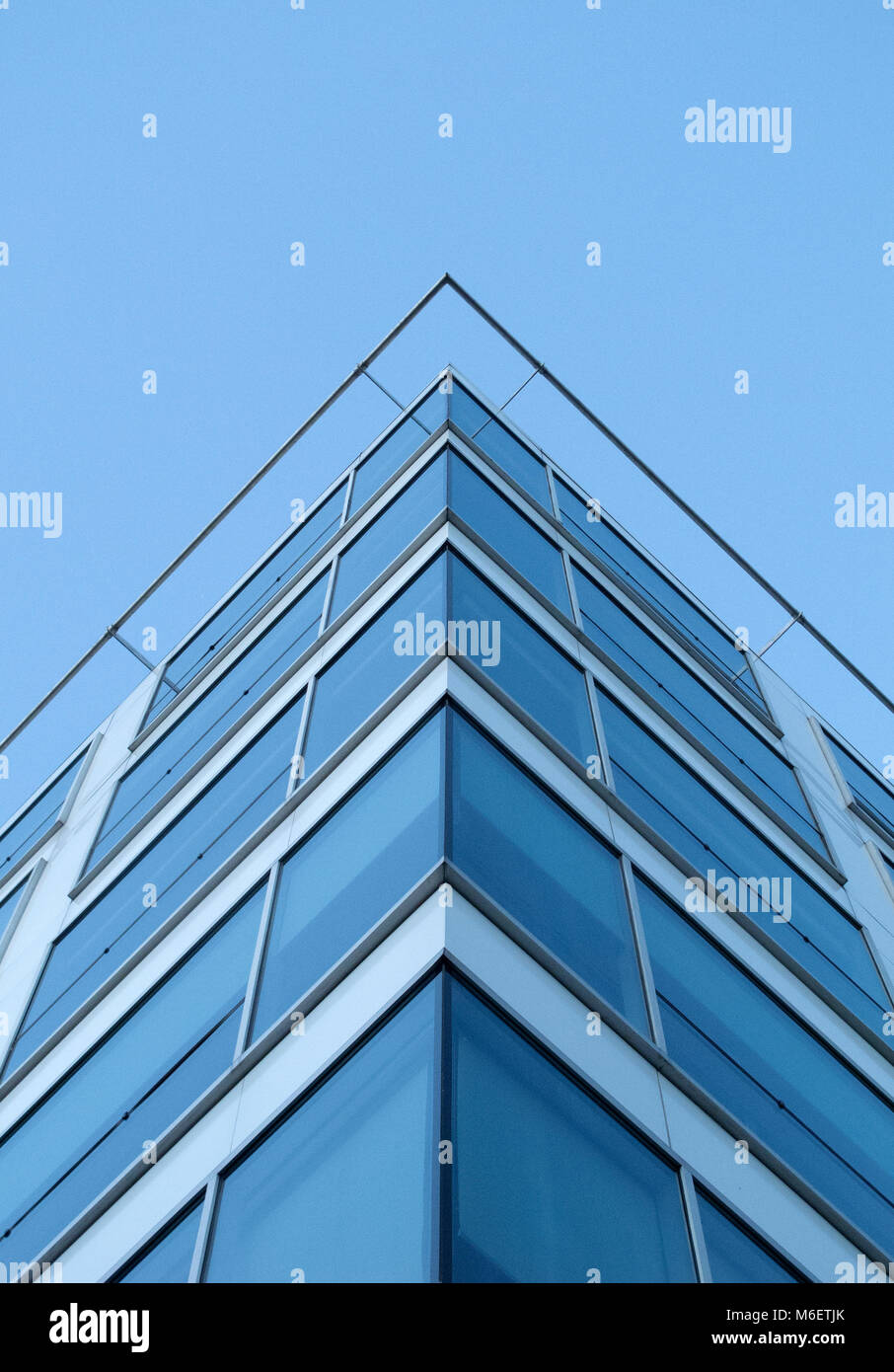 Symmetrical view of the glass facade of an office building Stock Photo ...