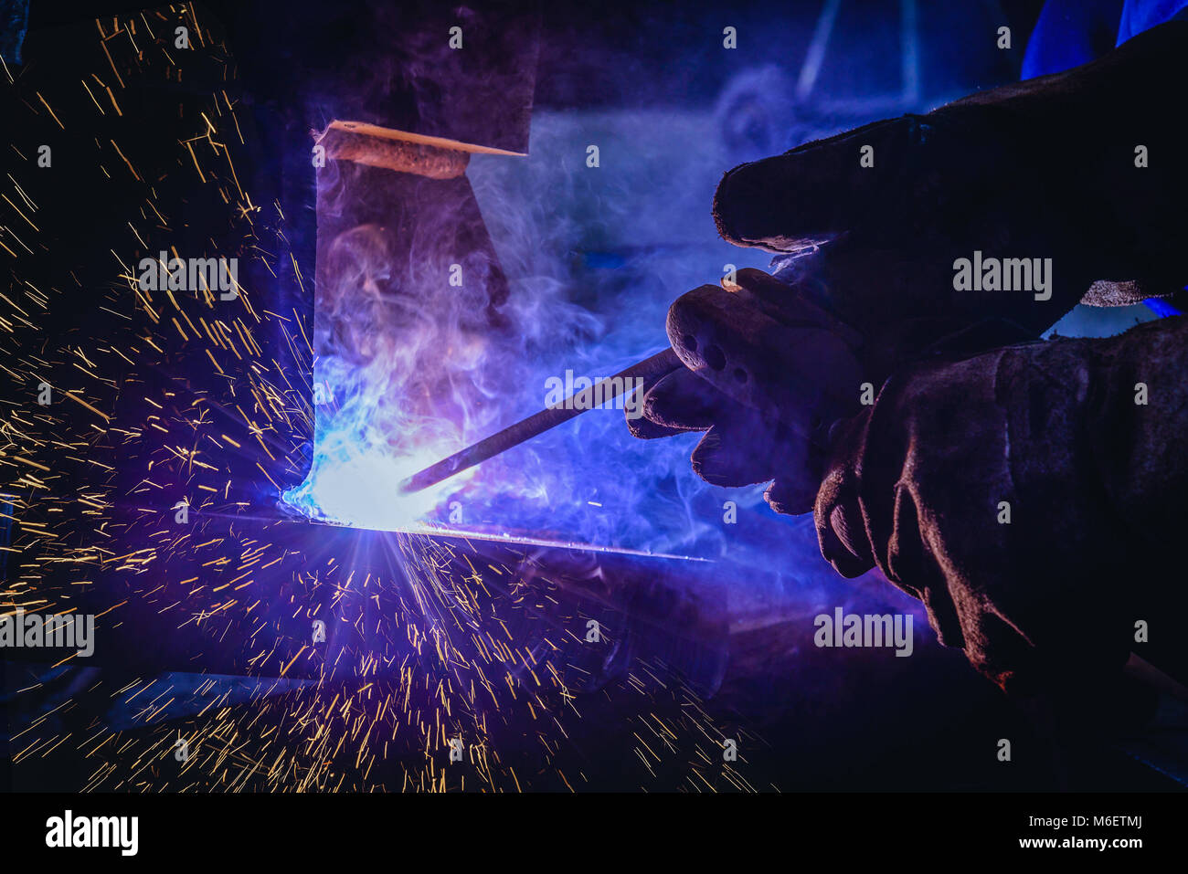 Welding steel structures and bright sparks with lens flare Stock Photo ...