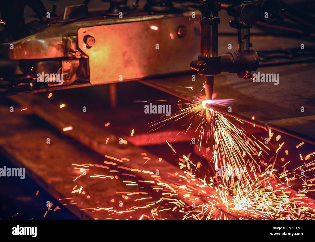 Worker cutting steel plate with acetylene welding cutting torch and ...