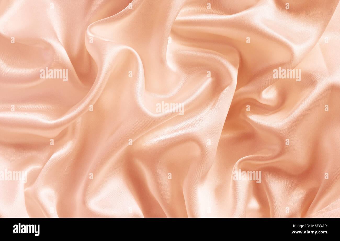 Closeup of peach silk fabric for background Stock Photo - Alamy