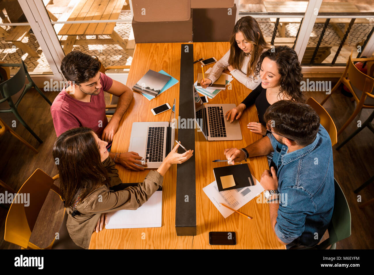 Groups of friends studying together on the bibliotech Stock Photo - Alamy