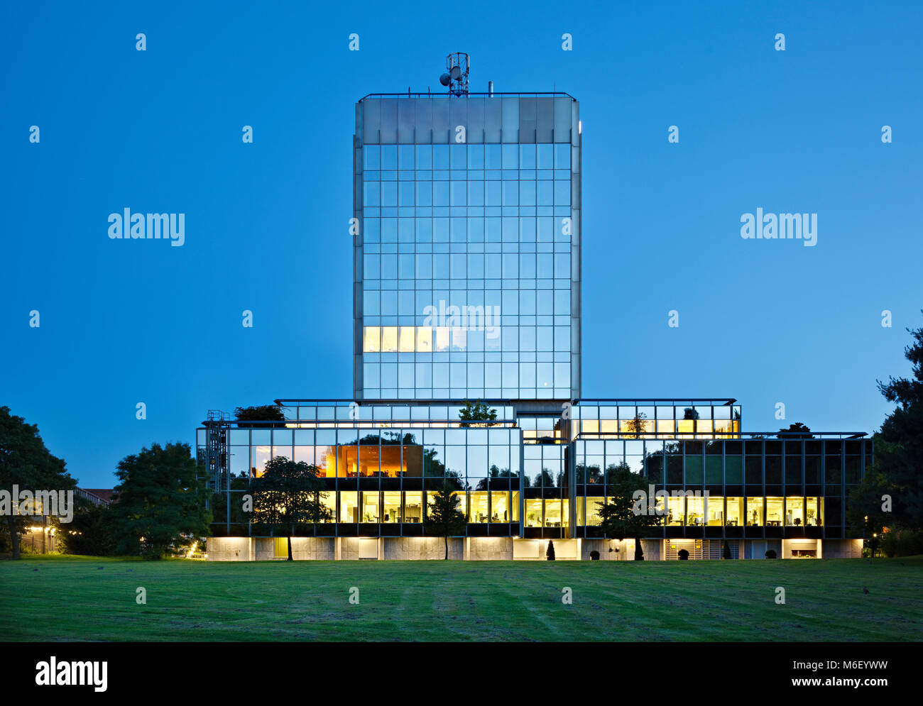 A modern steel and glass building with night blue sky Stock Photo - Alamy