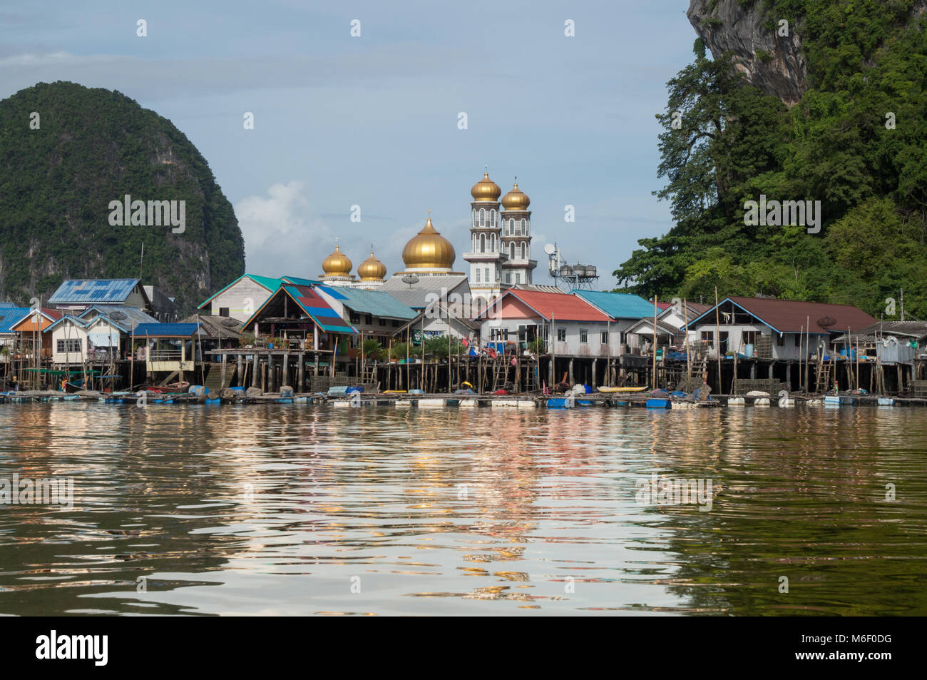 The "sea gypsy" village of Koh Panyee with its golden domed mosque is ...