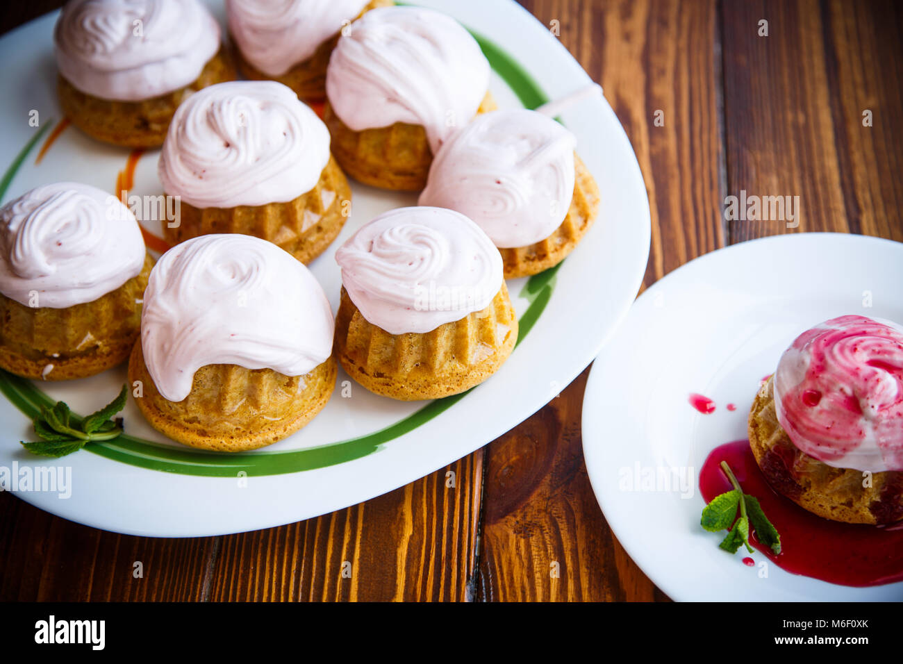sweet muffins with berry cream Stock Photo - Alamy