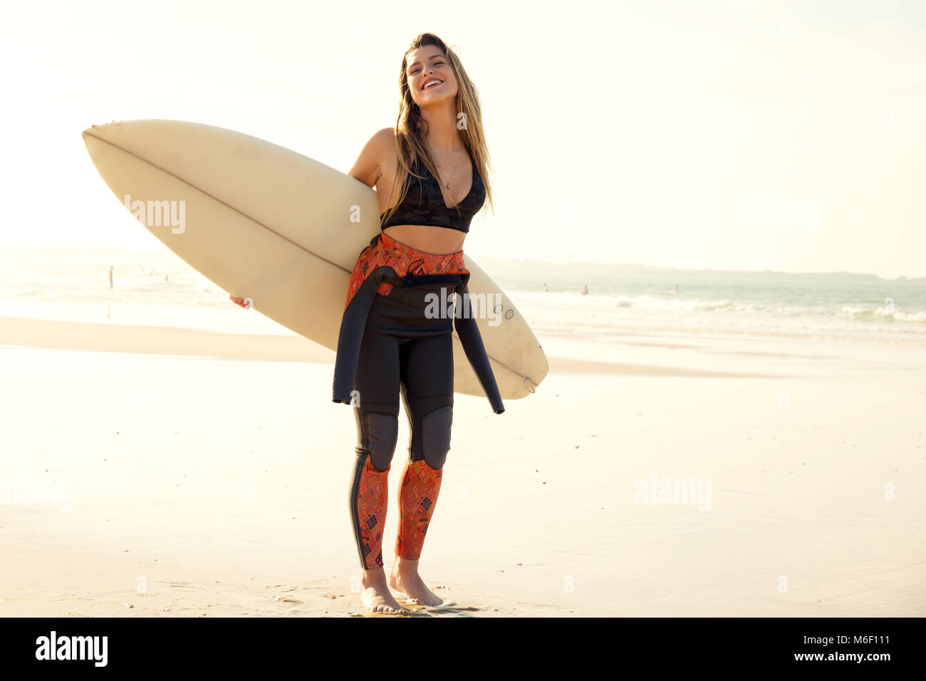 Woman holding surfing board hi-res stock photography and images - Alamy