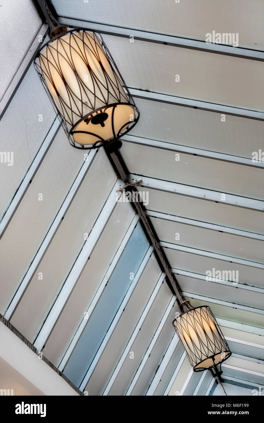 Glass ceiling with art decor glass lamp shades Stock Photo - Alamy