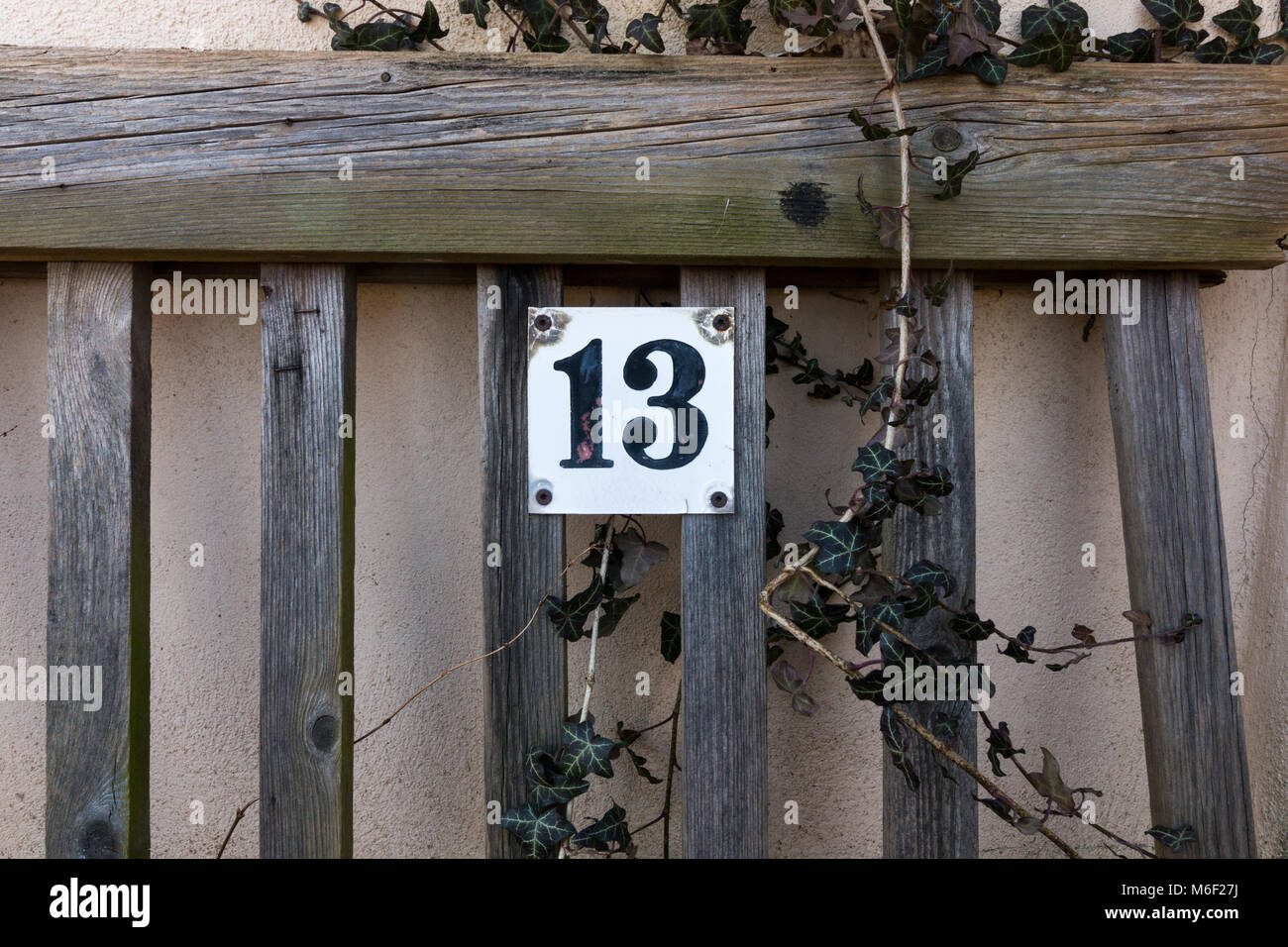 The number 13 on an old park bench. Symbol picture for Friday the 13th ...