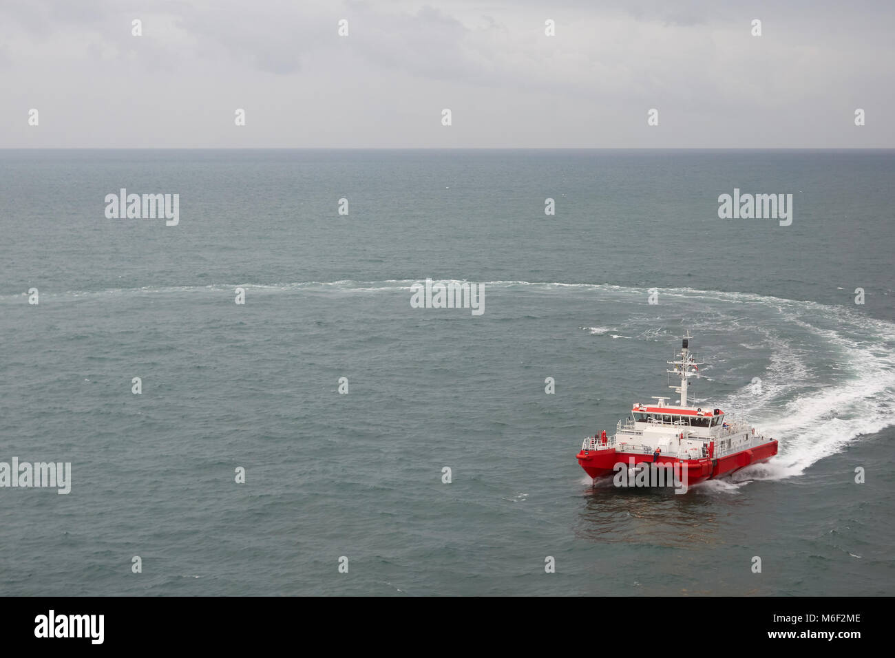 Modern tugboat of red and white color in the sea Stock Photo - Alamy