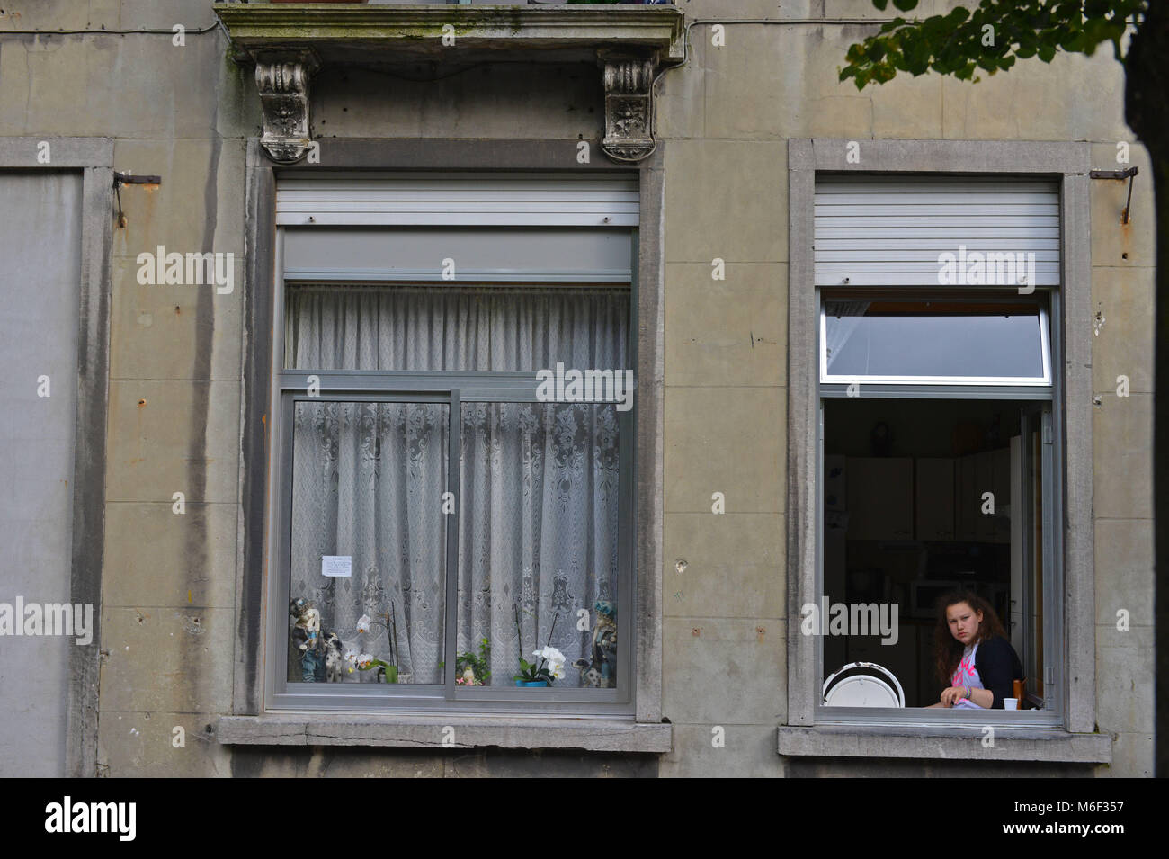 Bruxelles. Girl facing out a window, Molenbeek. Belgium Stock Photo - Alamy