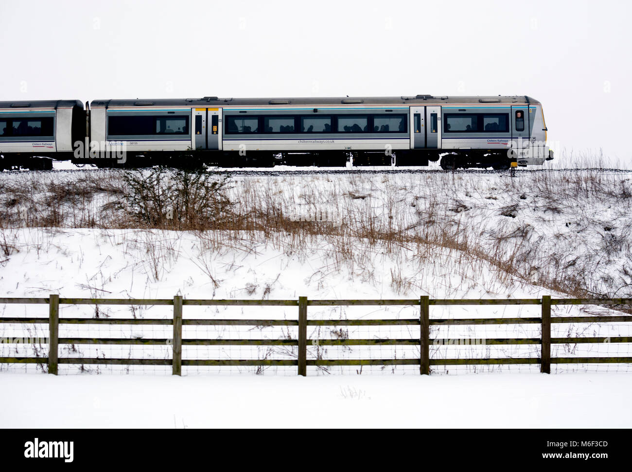 A Chiltern Railways class 168 train, side view, snowy in winter ...