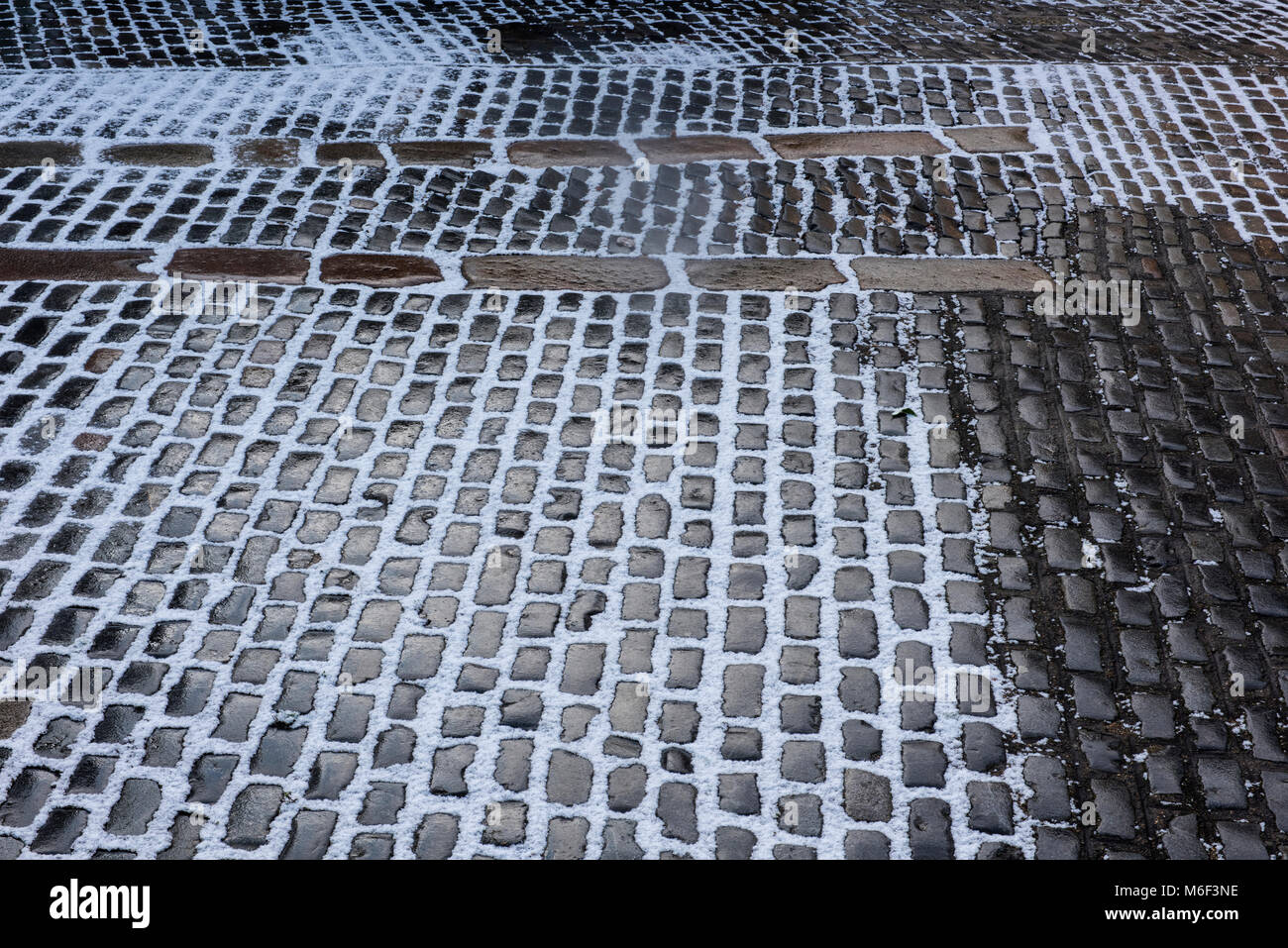 Snow covered cobbles on an icy road in central london. Icy roads in ...