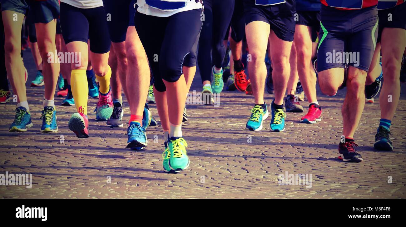group of runners on the finish line of an exciting marathon race ...