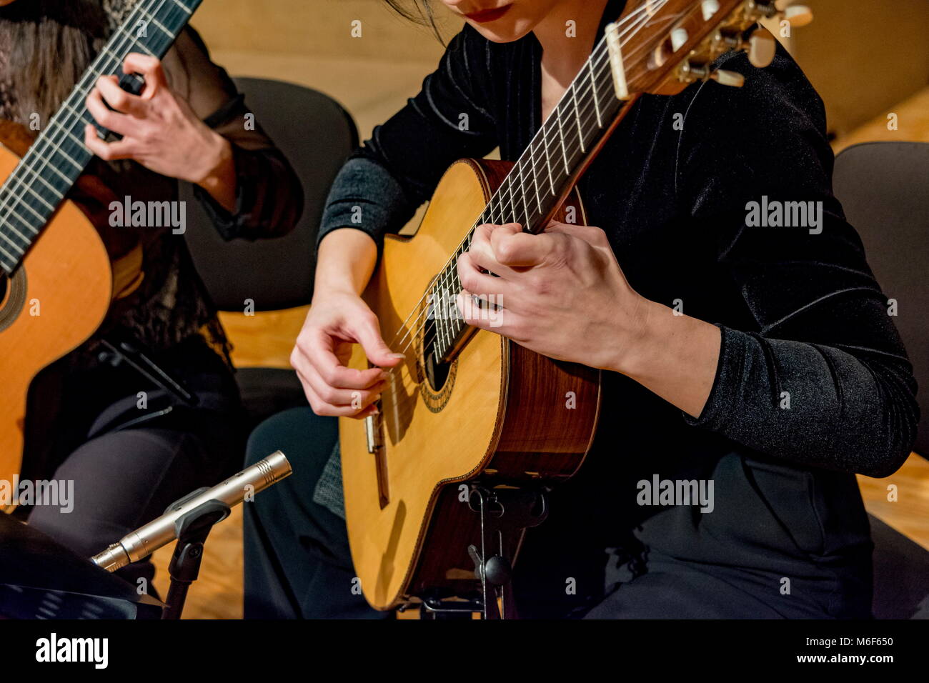 Lady playing a guitar hi-res stock photography and images - Alamy