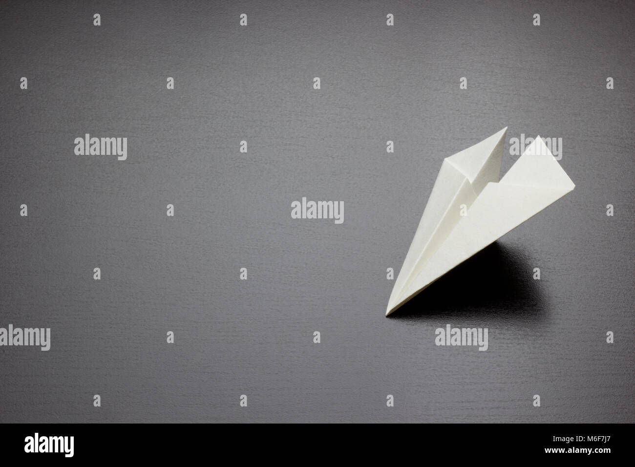 paper air plane on dark background for design Stock Photo - Alamy