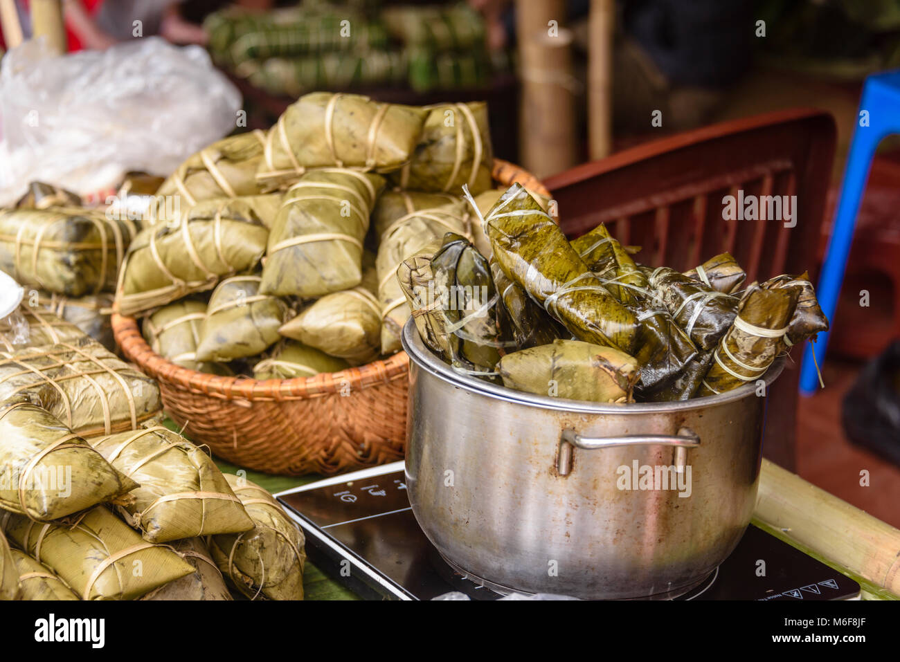 Sticky rice parcels wrapped up in bamboo leaves to be cooked in Hanoi ...