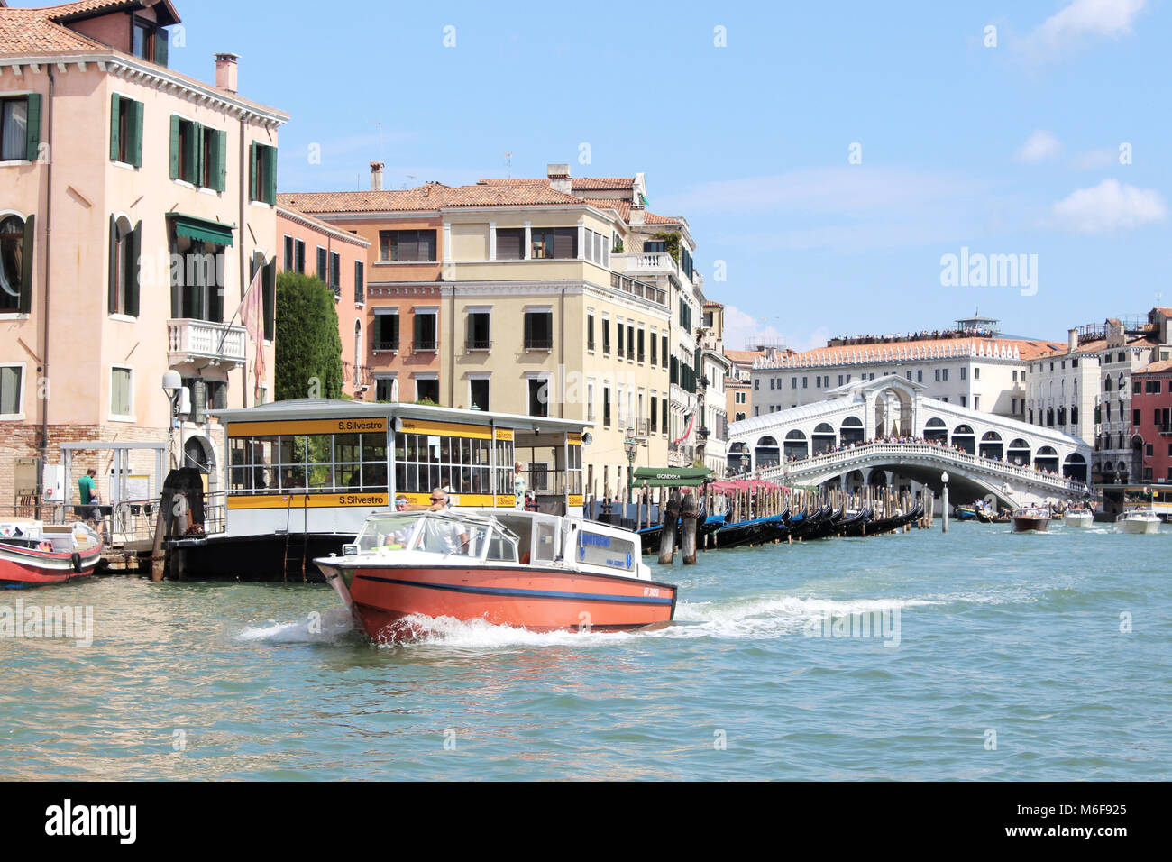 Rialto Bridge across the Grand Canal is the oldest and most famous ...