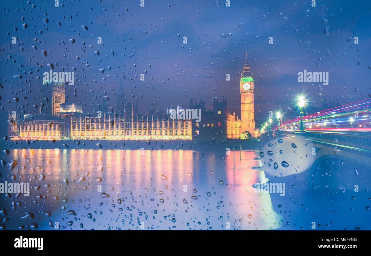 Big Ben view through the window with raindrops at night, London, UK ...