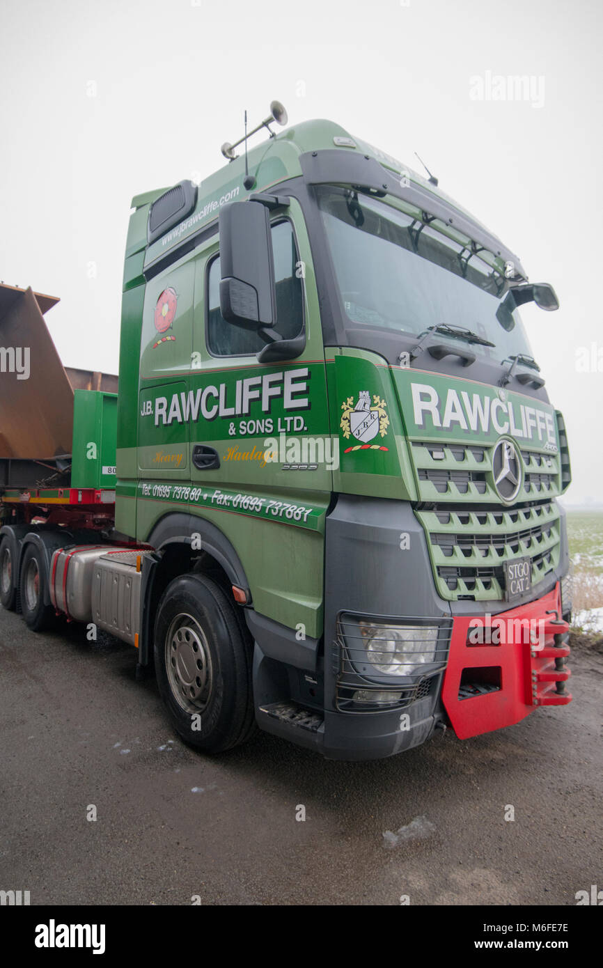 Heavy haulage trucks carrying metal for bridge construction for the ...