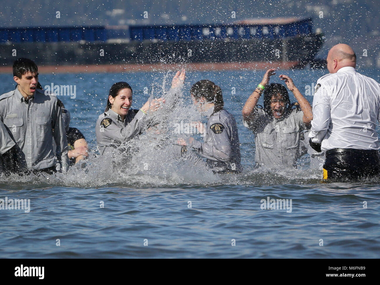 Vancouver, Canada. 3rd Mar, 2018. Police officers dip into the water to ...