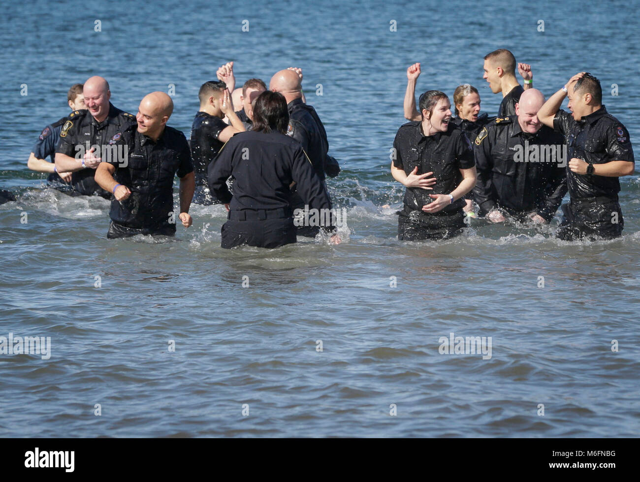 Vancouver, Canada. 3rd Mar, 2018. Police officers dip into the water to ...