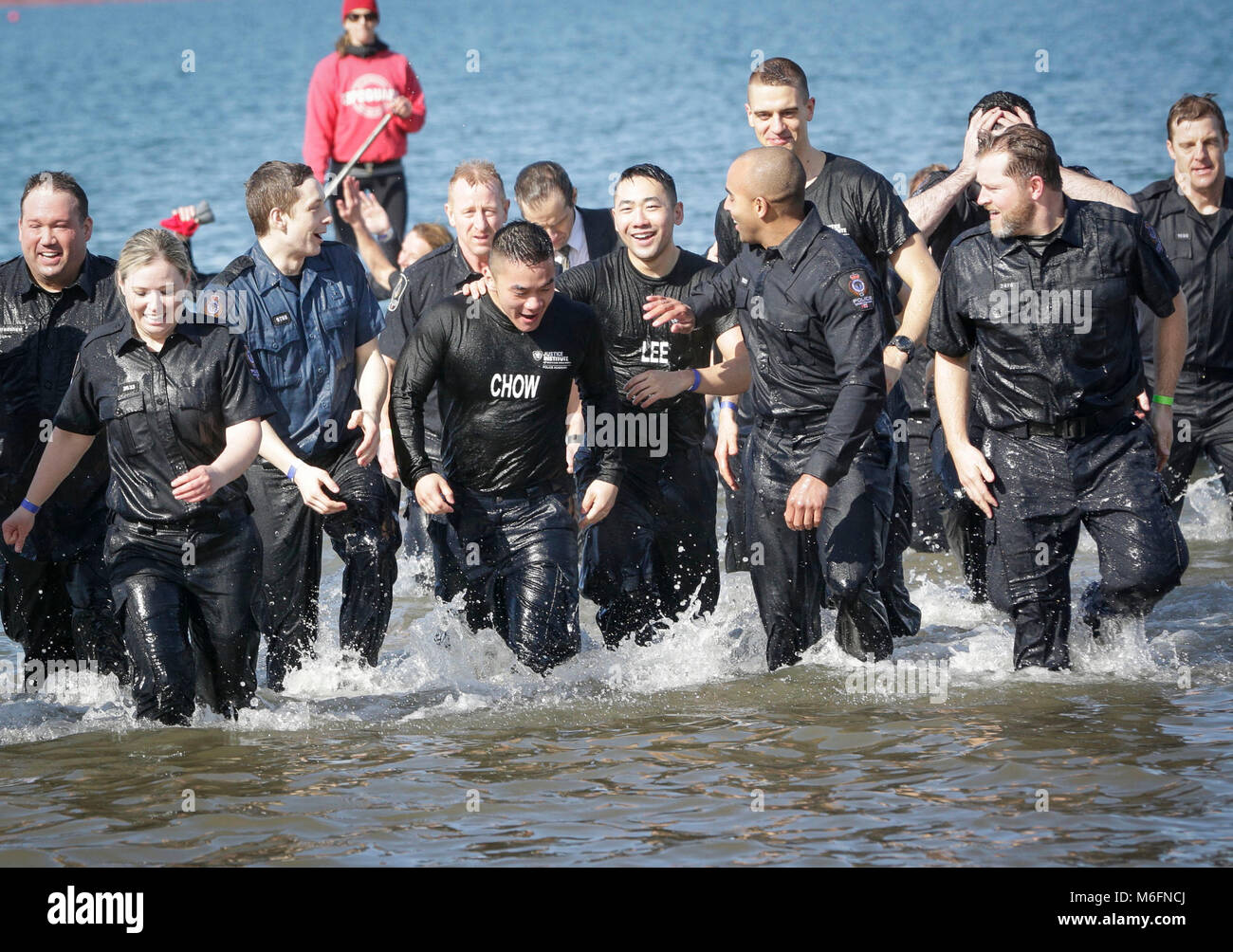 Vancouver, Canada. 3rd Mar, 2018. Police officers dip into the water to ...
