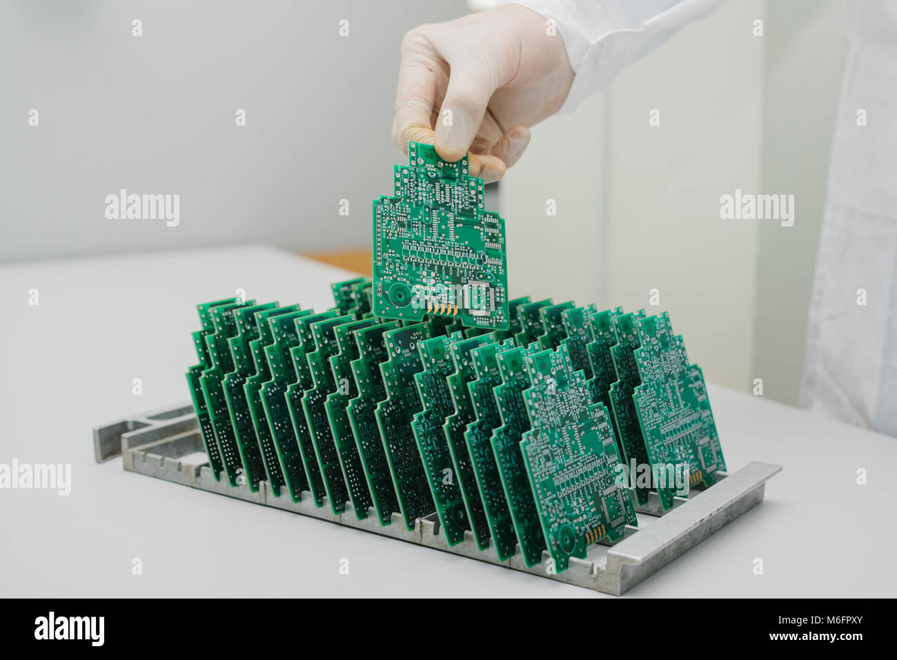 The technician takes a computer board with chips. Spare parts and ...