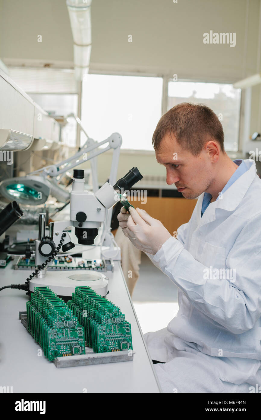 Computer expert professional technician examining board computer in a ...