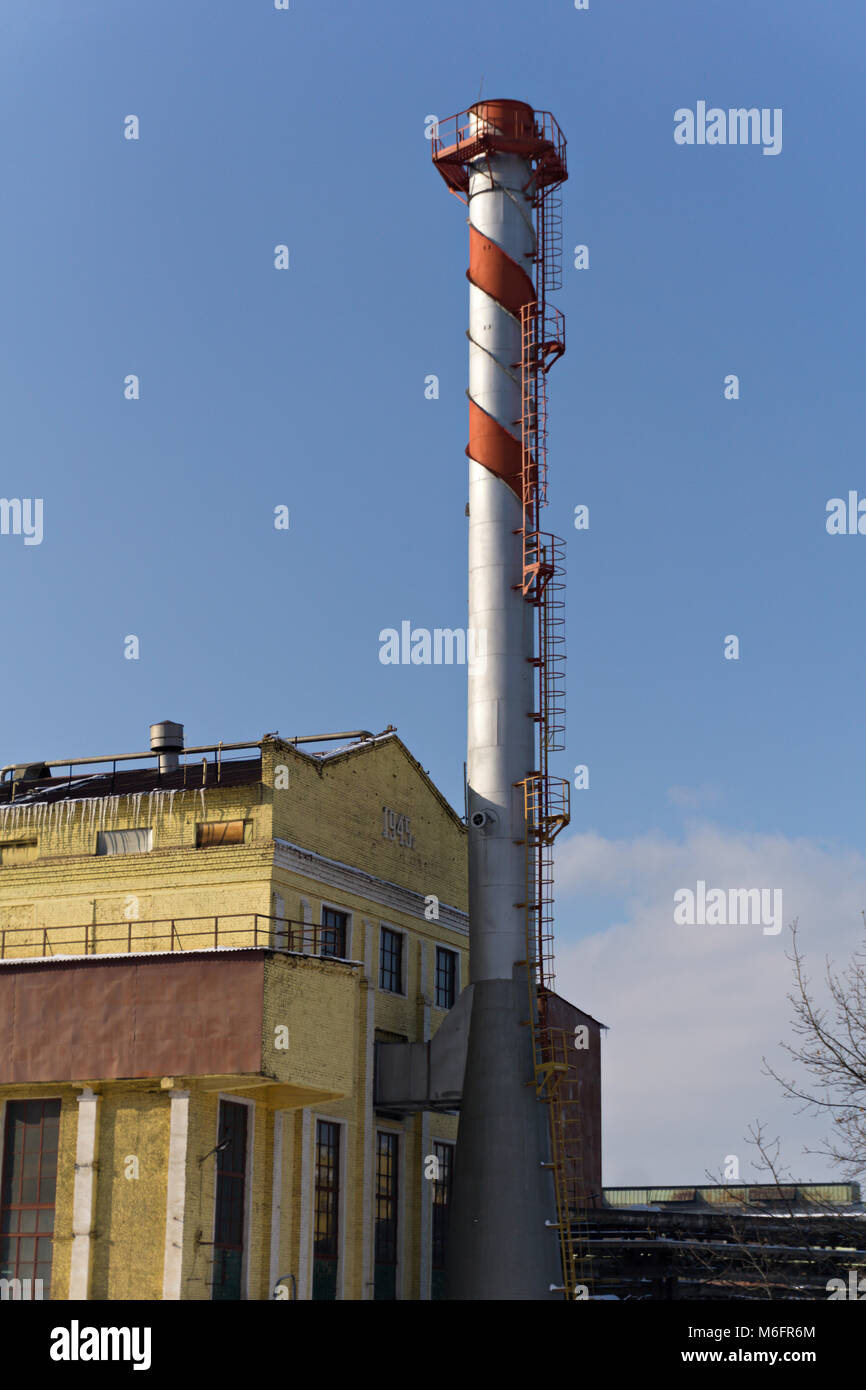 industrial steel spiral chimney near the old factory building Stock ...