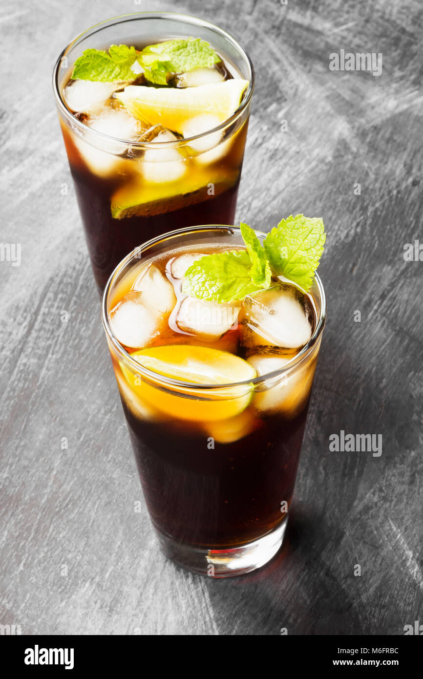 Two glasses of cocktail Cuba Libre on a dark background Stock Photo - Alamy