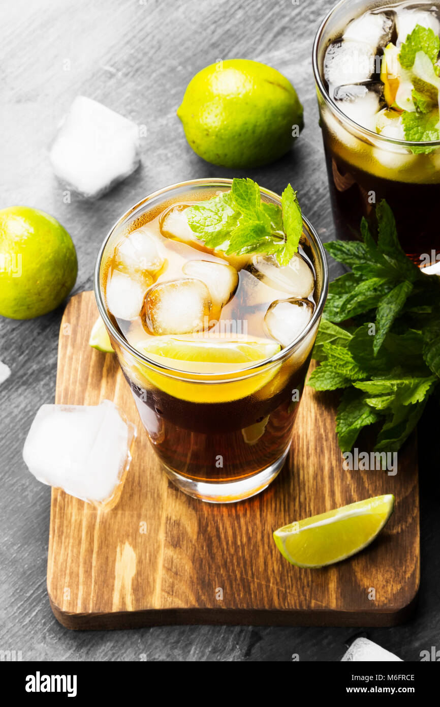 Two glasses of cocktail Cuba Libre on a dark background Stock Photo - Alamy