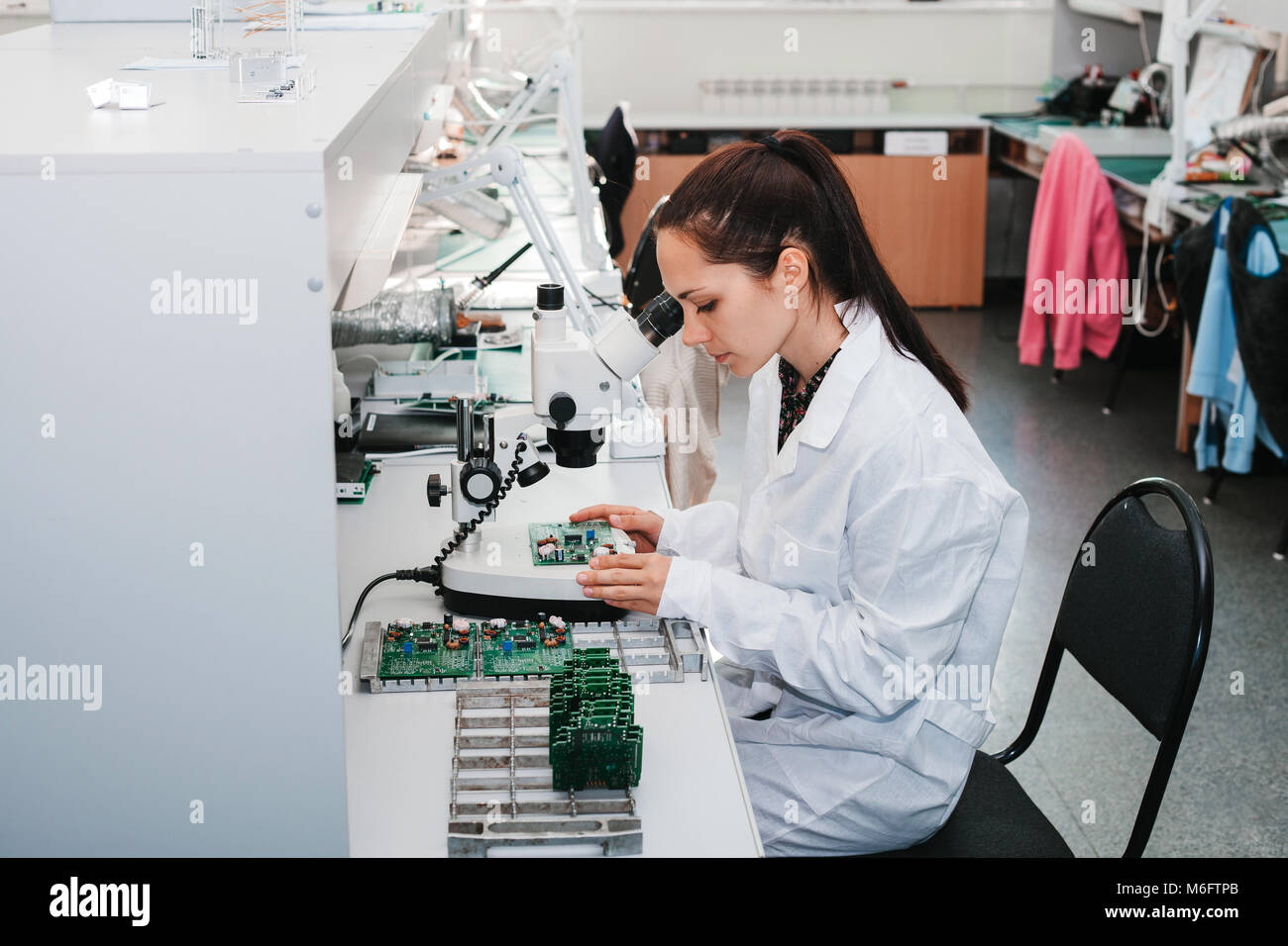 Beautiful female computer expert professional technician examining ...