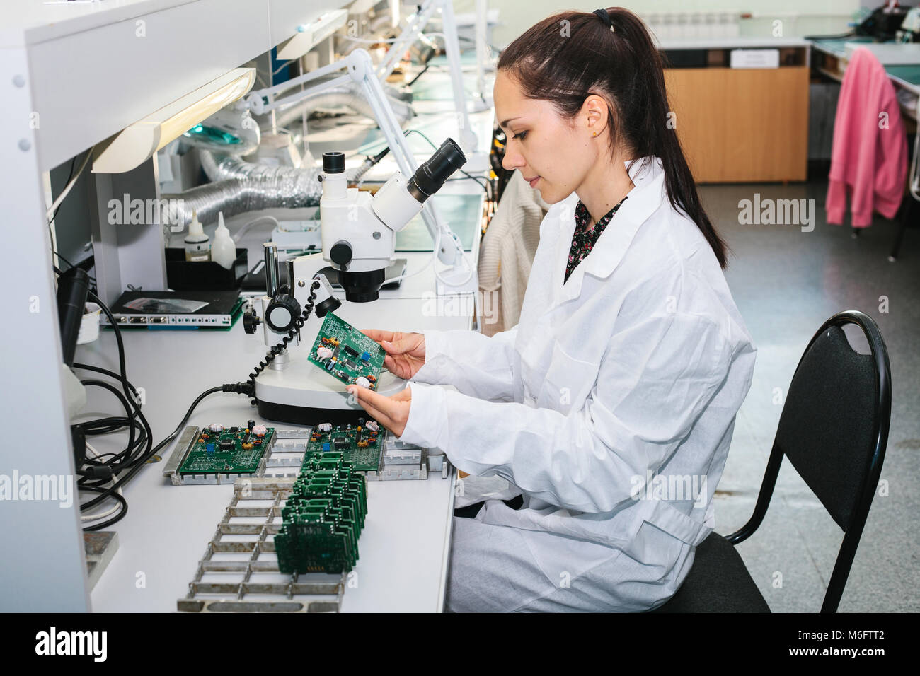 Beautiful female computer expert professional technician examining ... Beautiful female computer expert professional technician examining ...