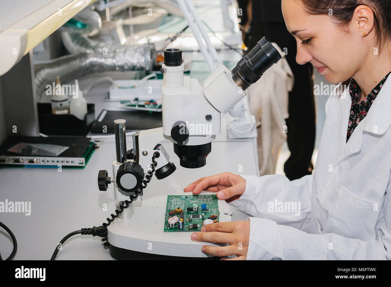Beautiful female computer expert professional technician examining ...