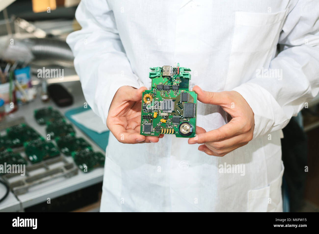 Technician with computer circuit board with chips. Spare parts and ...