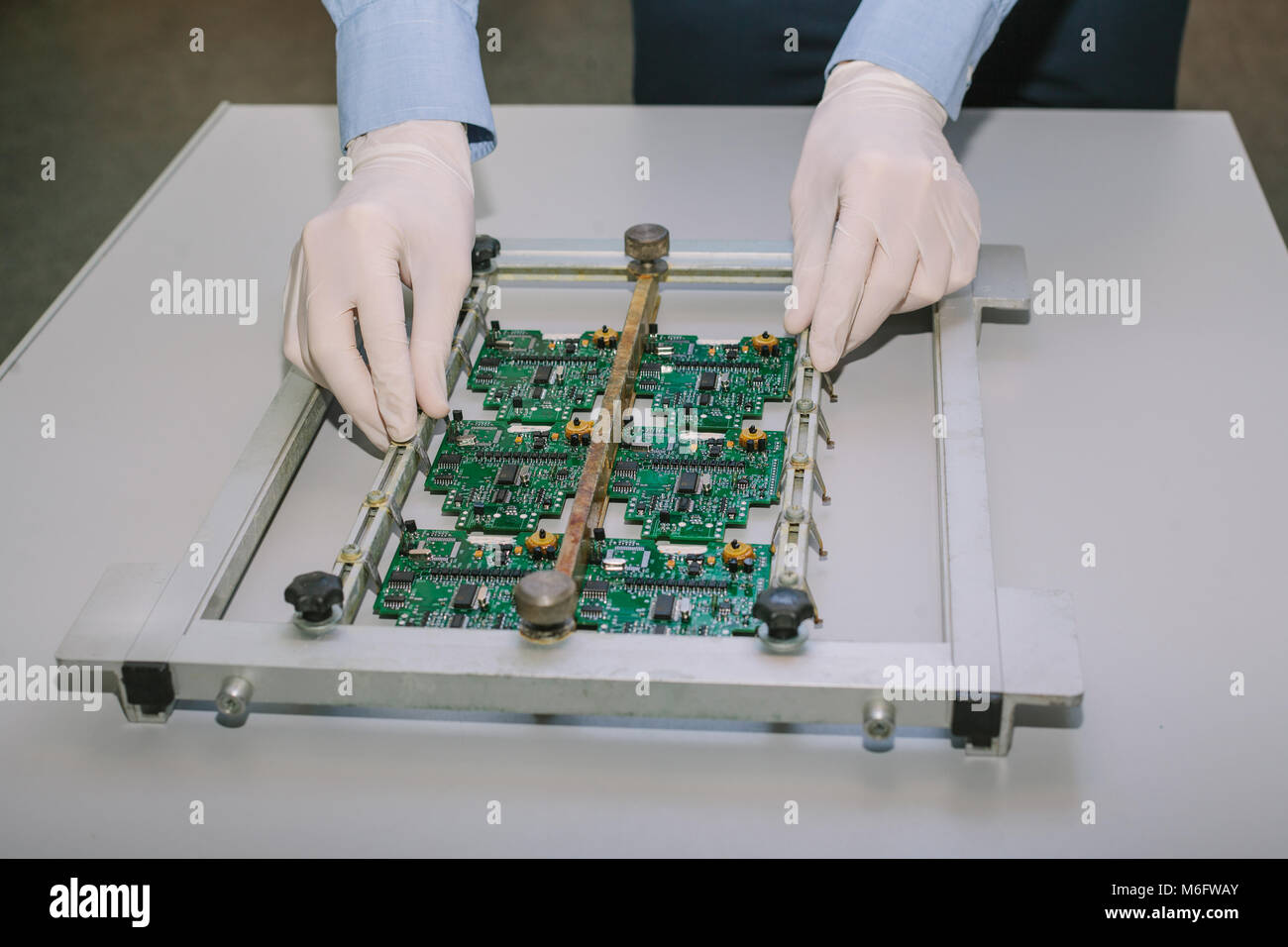 Technician with computer circuit board with chips. Spare parts and ...