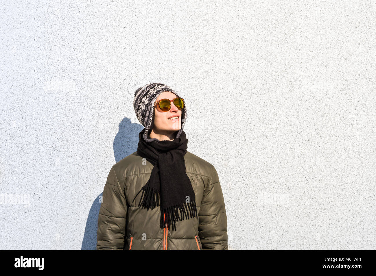 Smiling young man posing outdoors. Male teenager person stands at ...