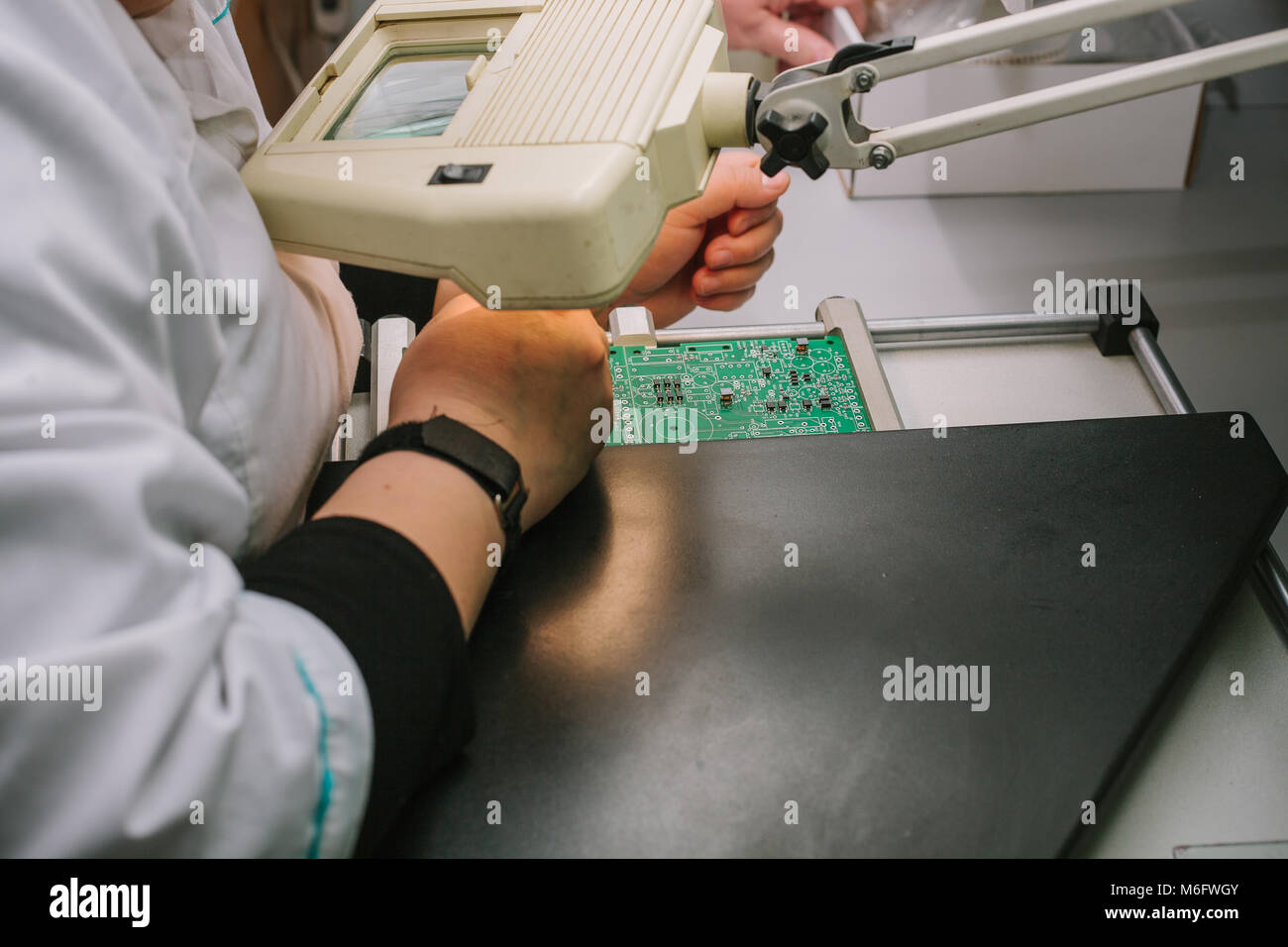 Female computer expert professional technician examining board computer ...