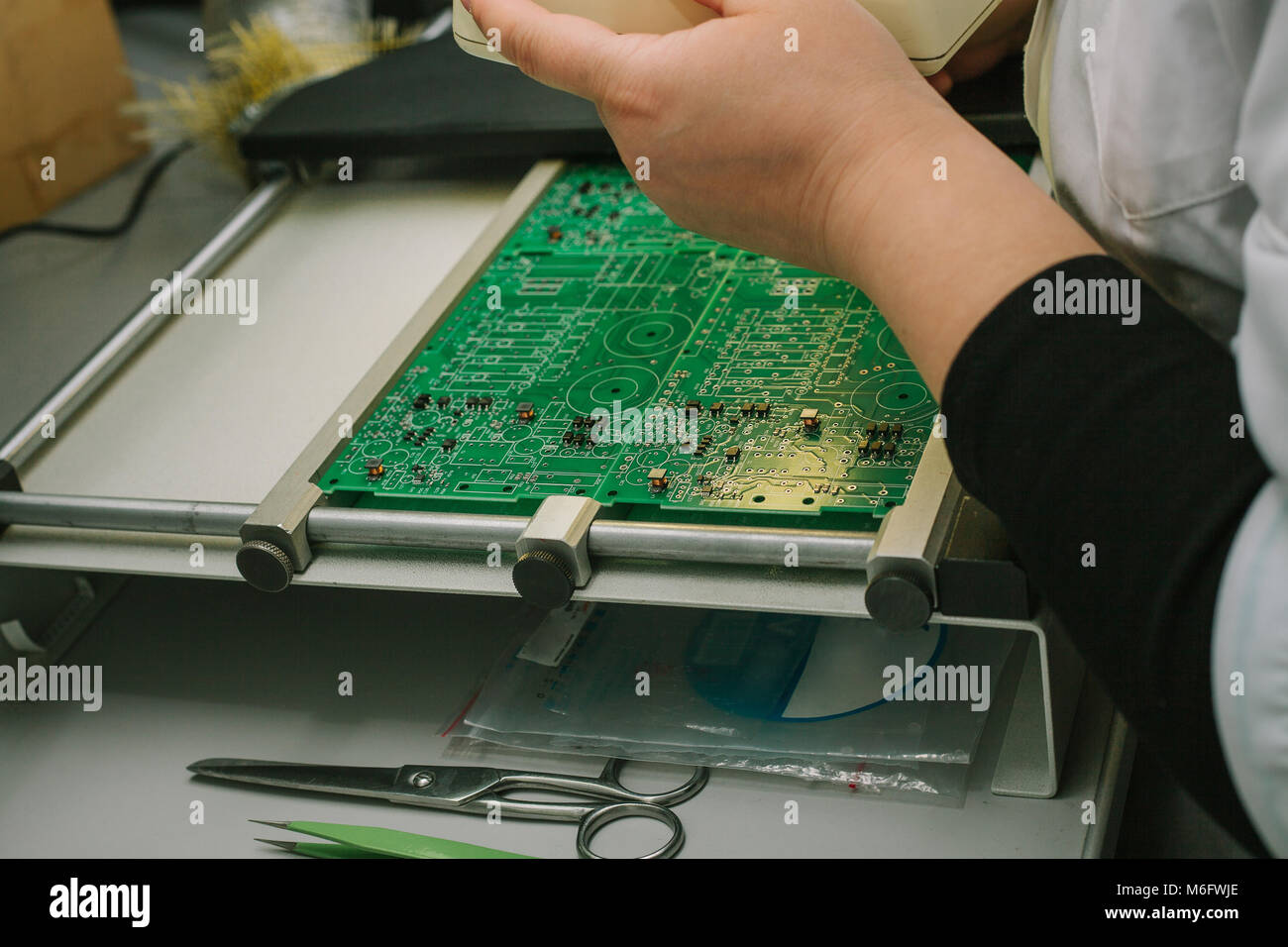 Female computer expert professional technician examining board computer ...