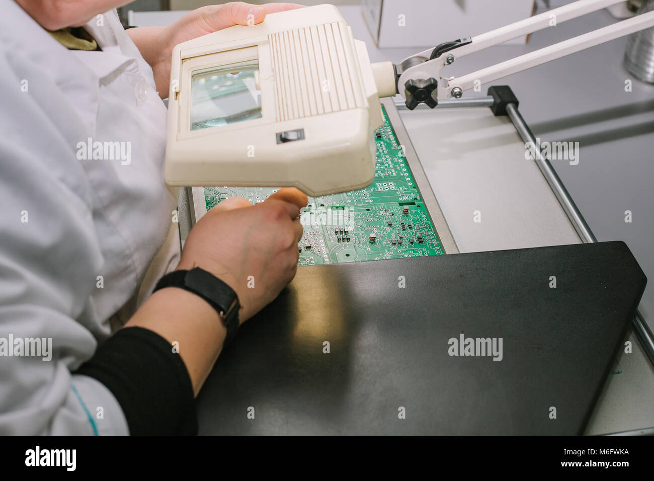 Female computer expert professional technician examining board computer ...