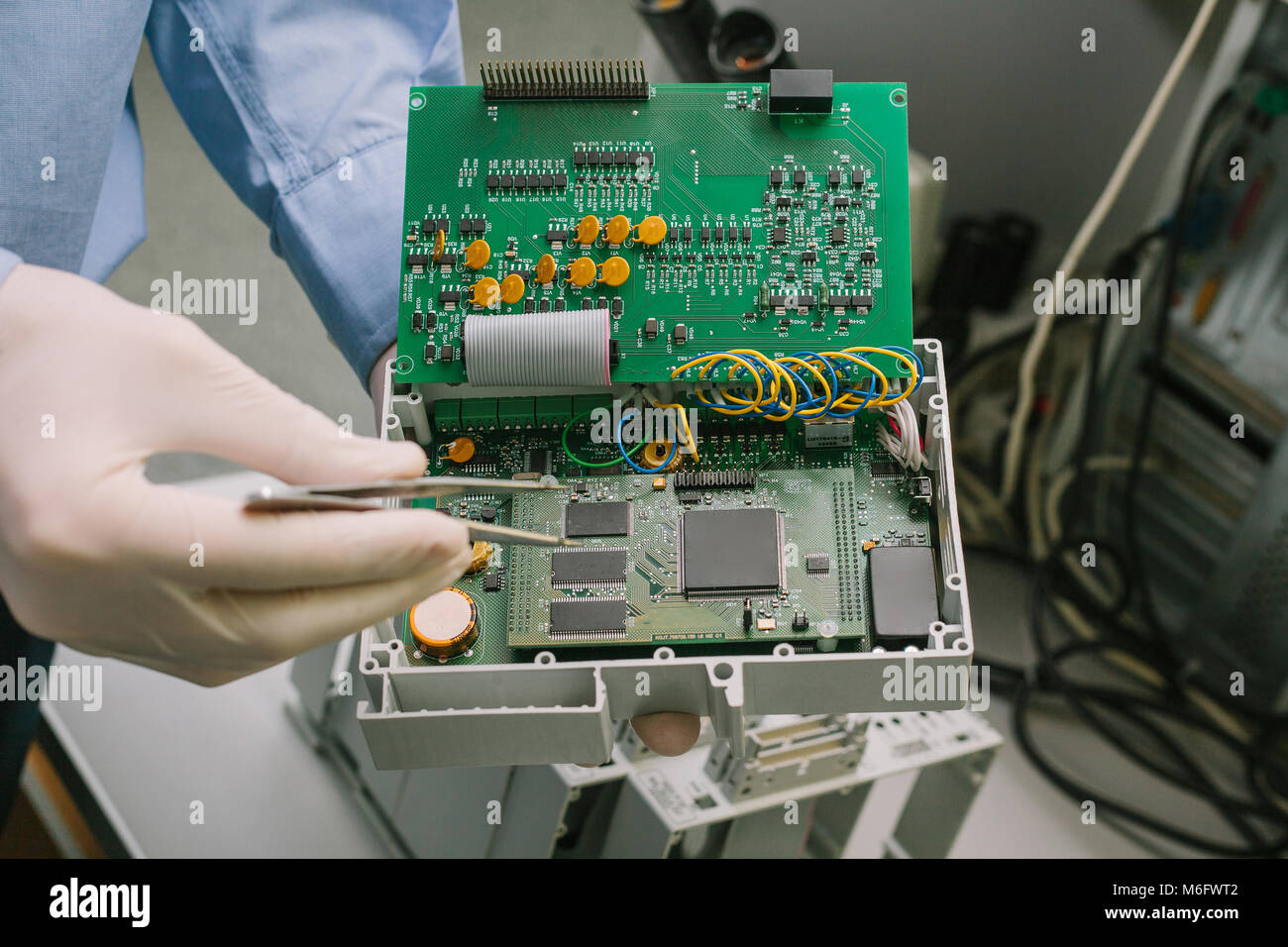 Computer expert professional technician examining board computer in a ...
