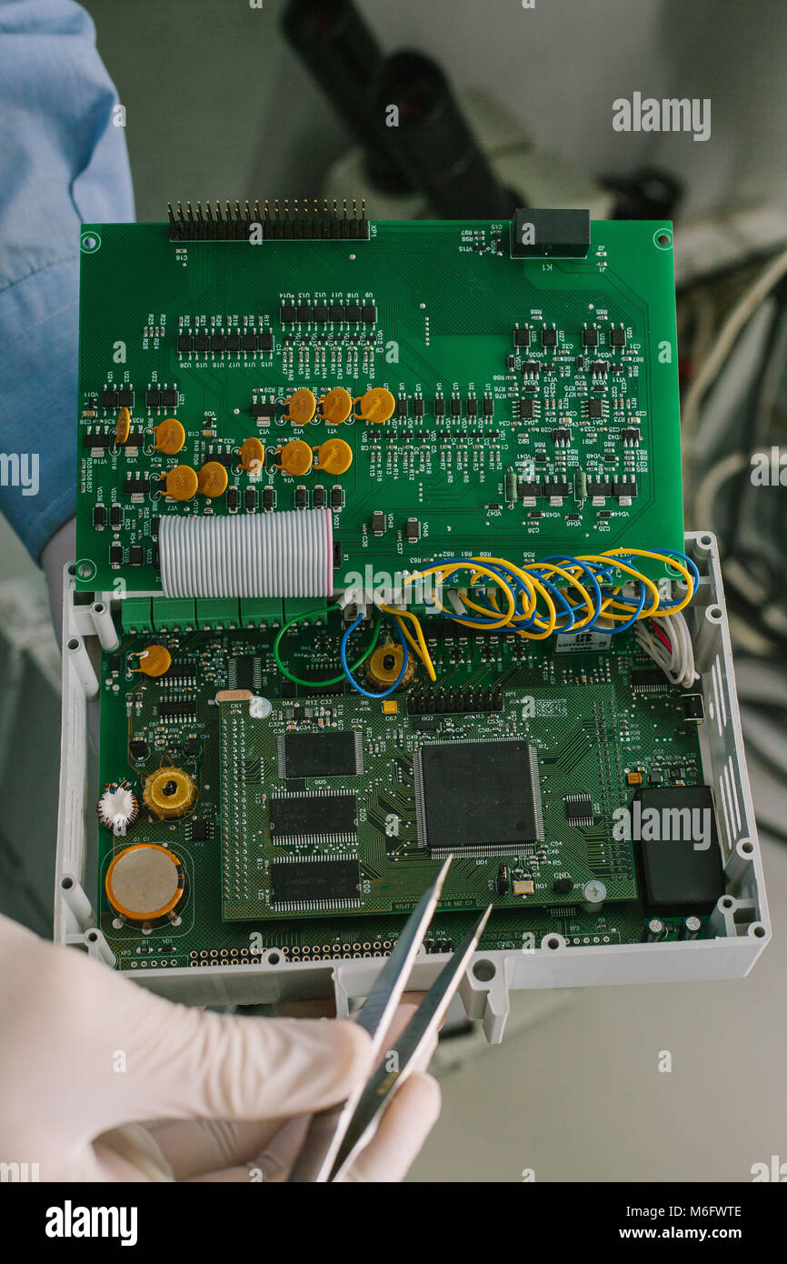 Computer expert professional technician examining board computer in a ...