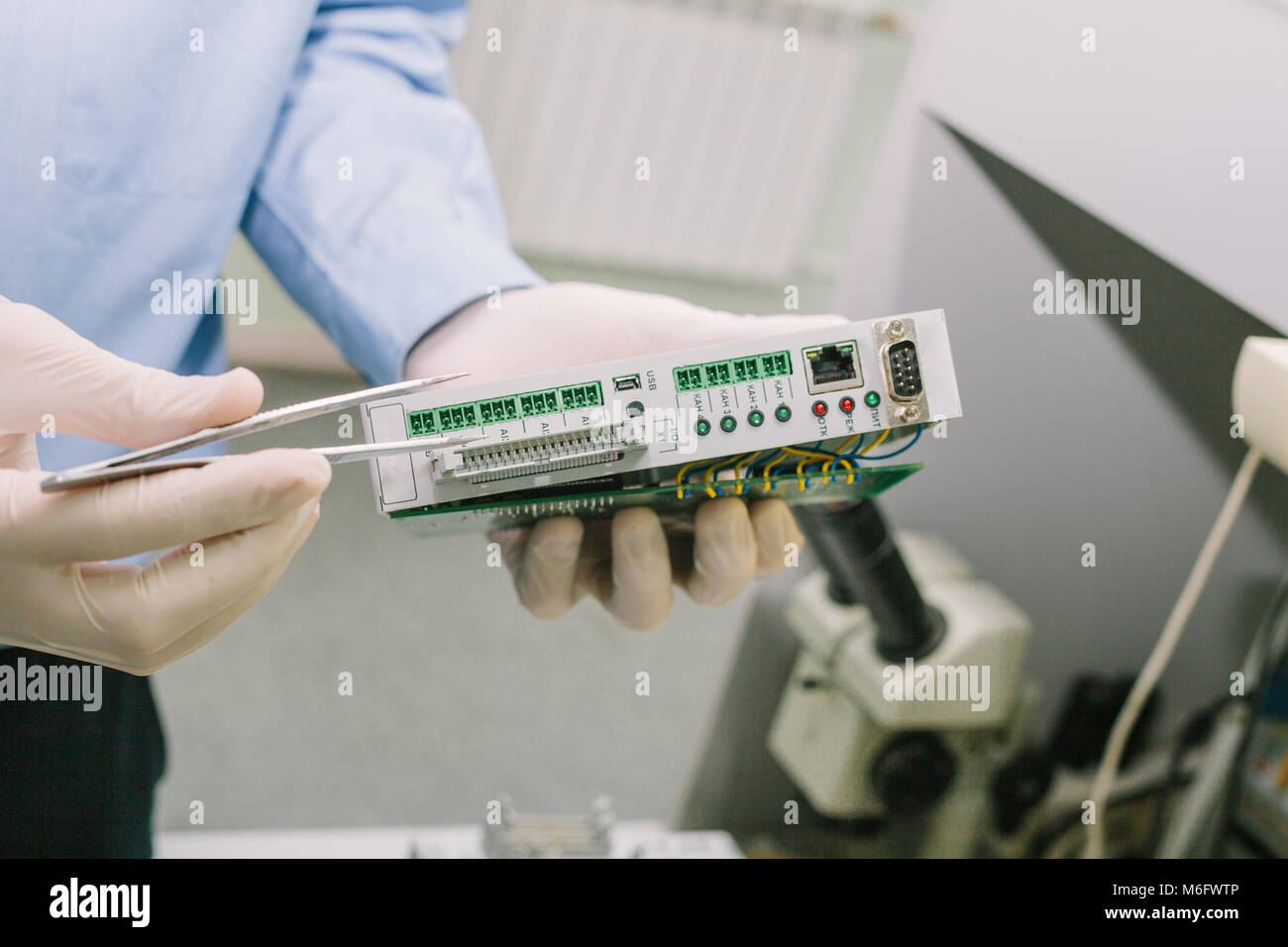 Computer expert professional technician examining board computer in a ...