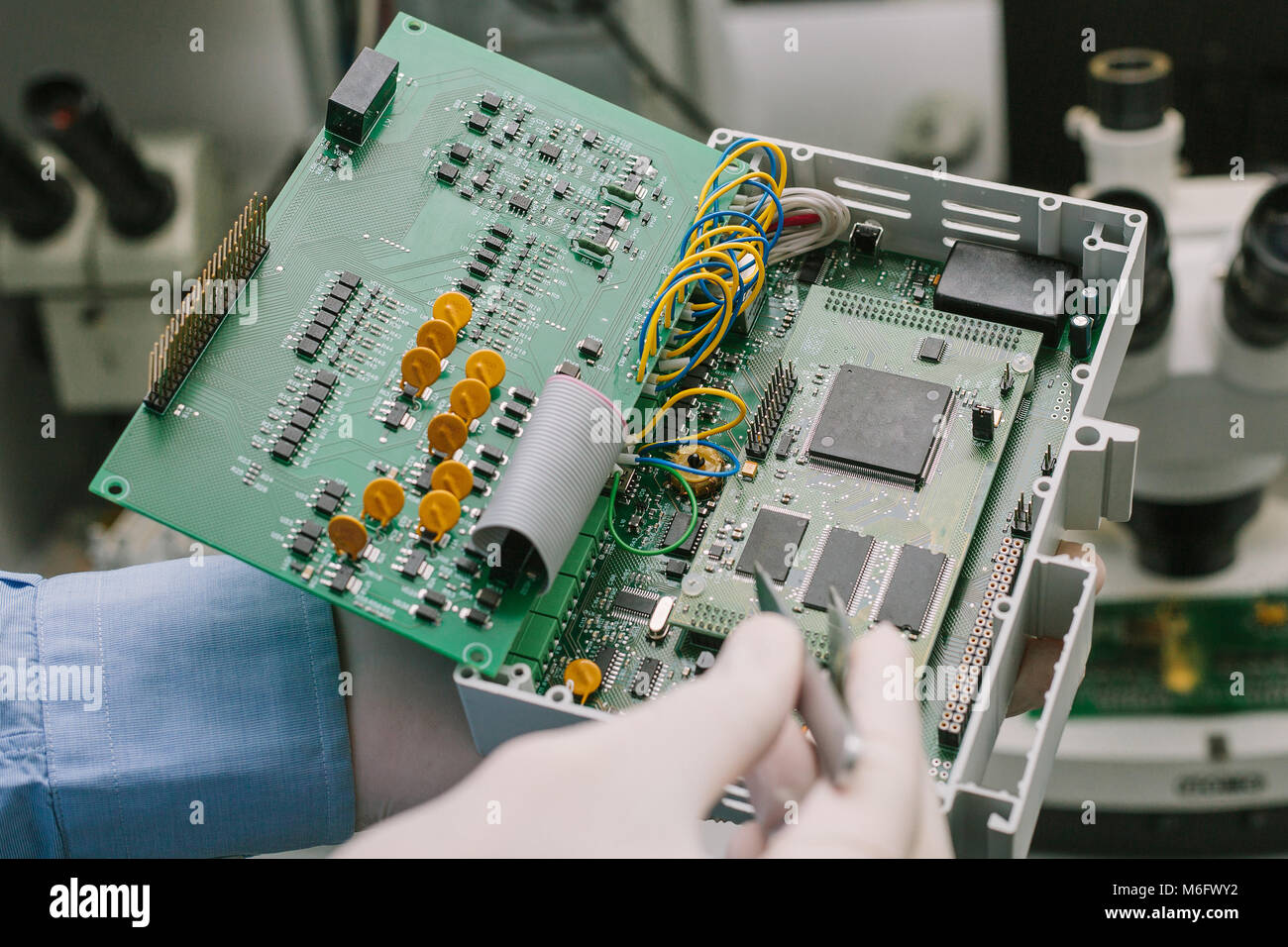 Computer expert professional technician examining board computer in a ...