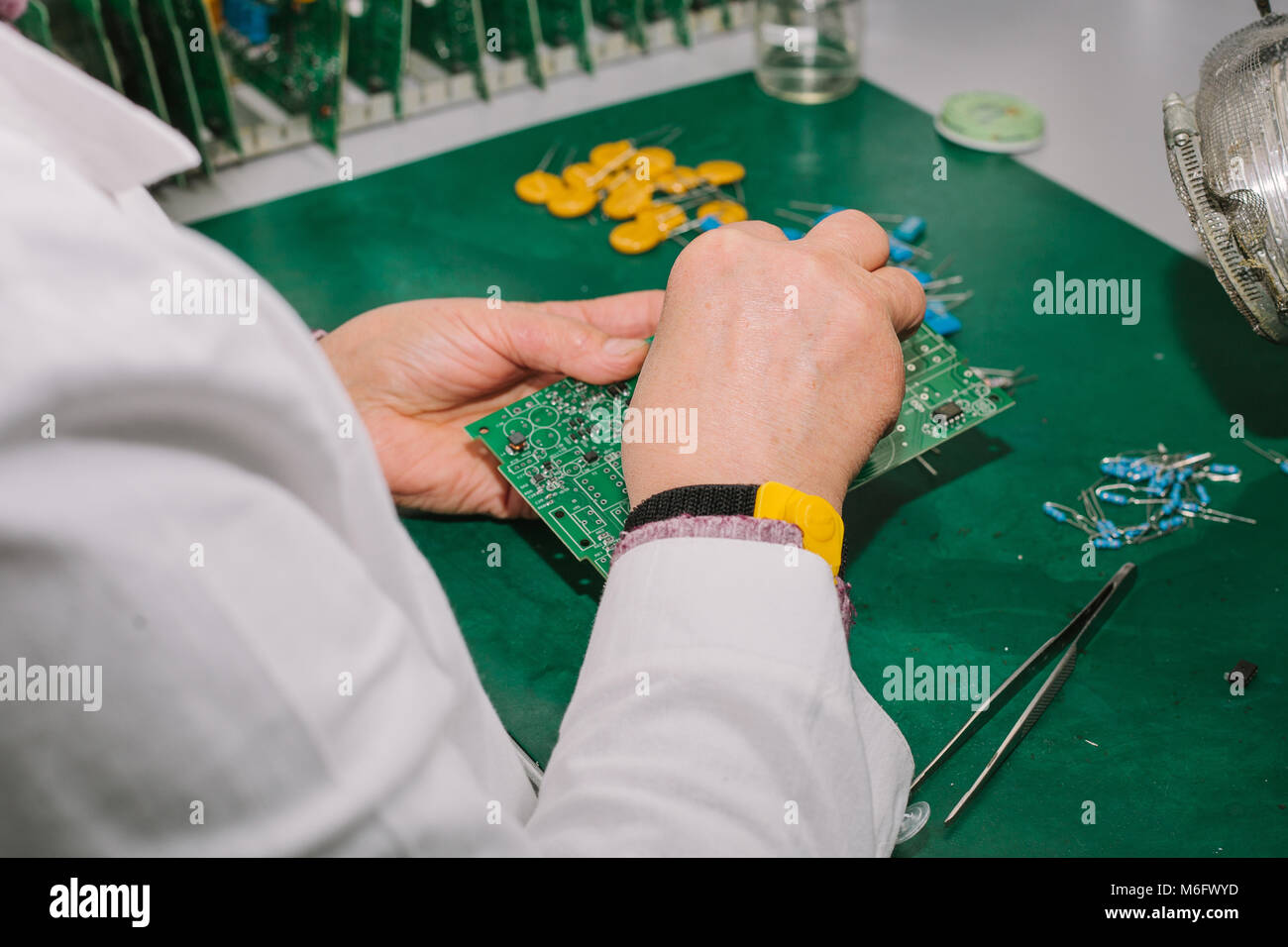 Female computer expert professional technician examining board computer ...