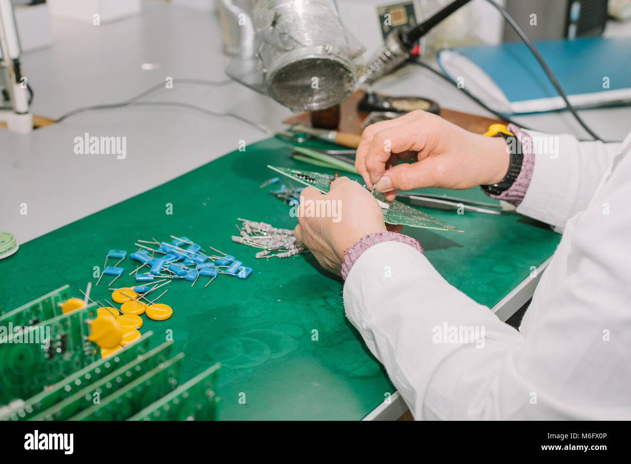 Female computer expert professional technician examining board computer ...