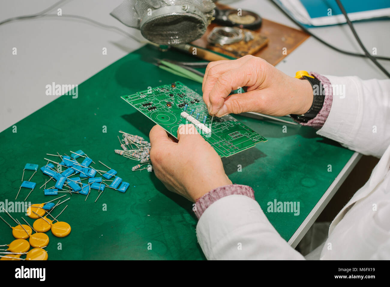 Female computer expert professional technician examining board computer ...