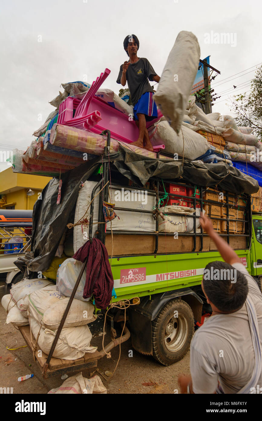 Mawlamyine (Mawlamyaing, Moulmein): men load truck, overloaded, , Mon ...