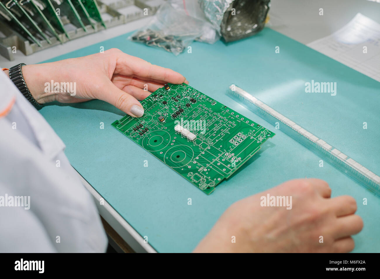 Female computer expert professional technician examining board computer ...